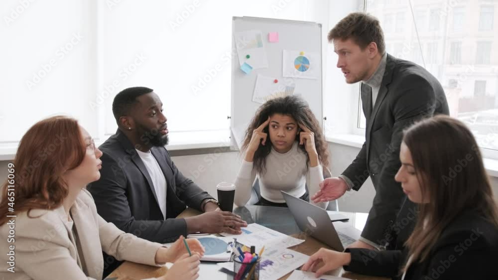 Diverse employees arguing during team meeting, african office worker ...
