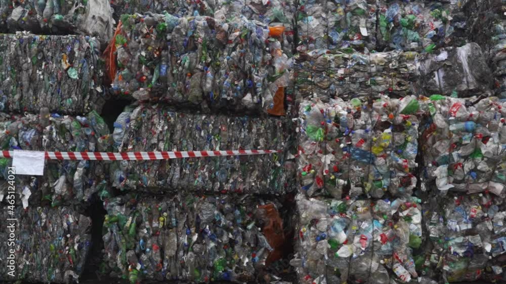 Bundle of pressed plastic bottles prepared for a garbage recycling on ...