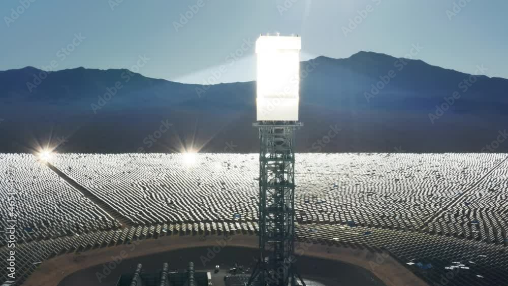 Cinematic view on tall solar tower with huge mirror panel accumulating ...