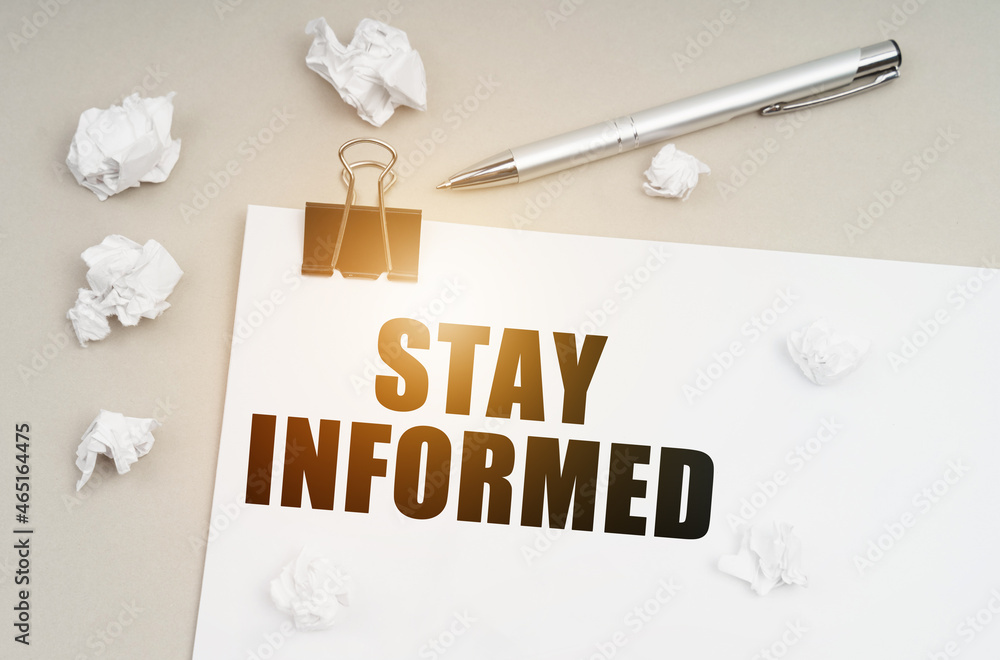 On a gray surface, a pen, crumpled paper and a sheet with the ...