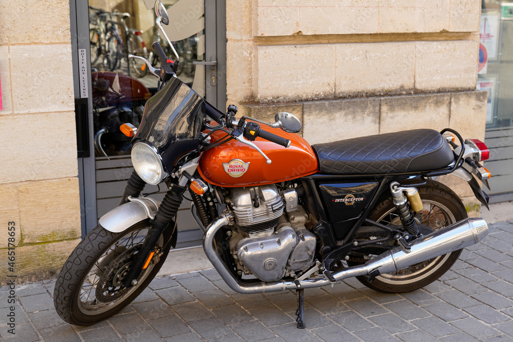 Royal Enfield motorcycle orange crush color parked in street vintage ...