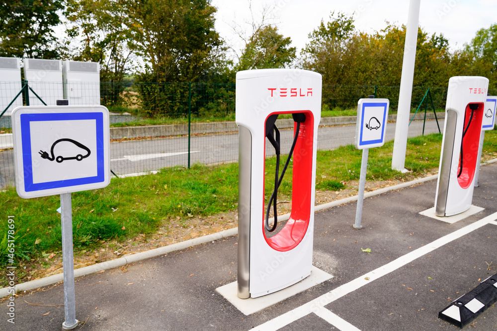 tesla red text sign and logo brand on white charger supercharger power ...
