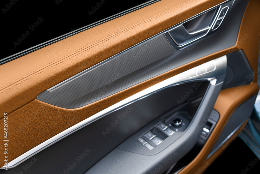 Car door handle inside the luxury modern car with brown leather texture ...