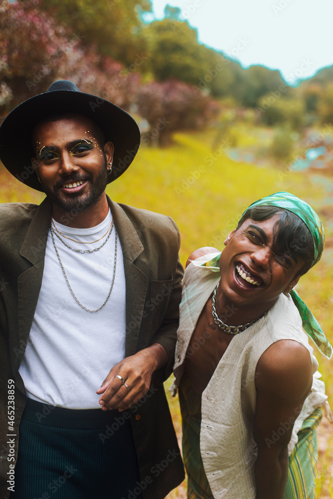 Two Malaysian Indian men surrounded by nature, walking in the grass ...