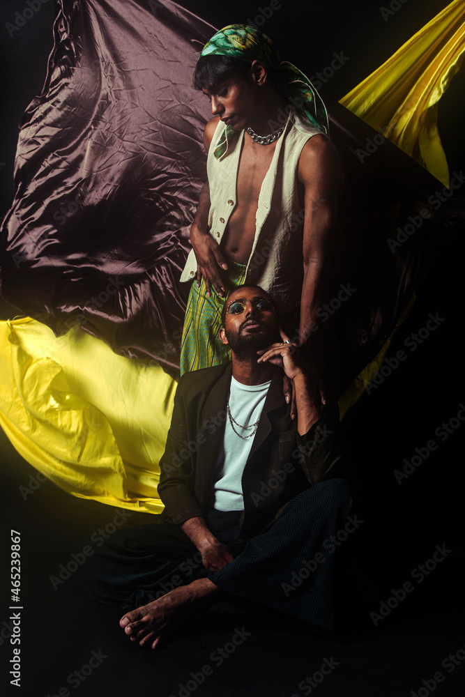 Two Malaysian Indian men in a studio setting with cloth flying in the ...