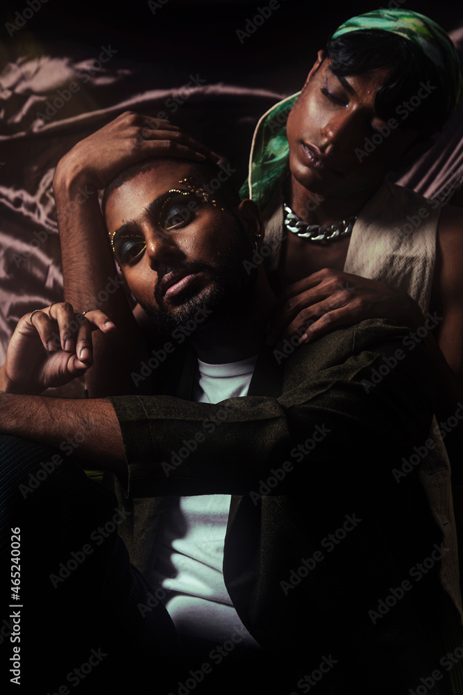 Two Malaysian Indian men in a studio setting with cloth flying in the ...
