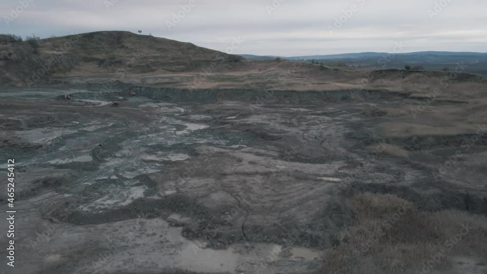 Tractor working on a clay quarry. Clay mining. Bulldozer. Clay deposits ...