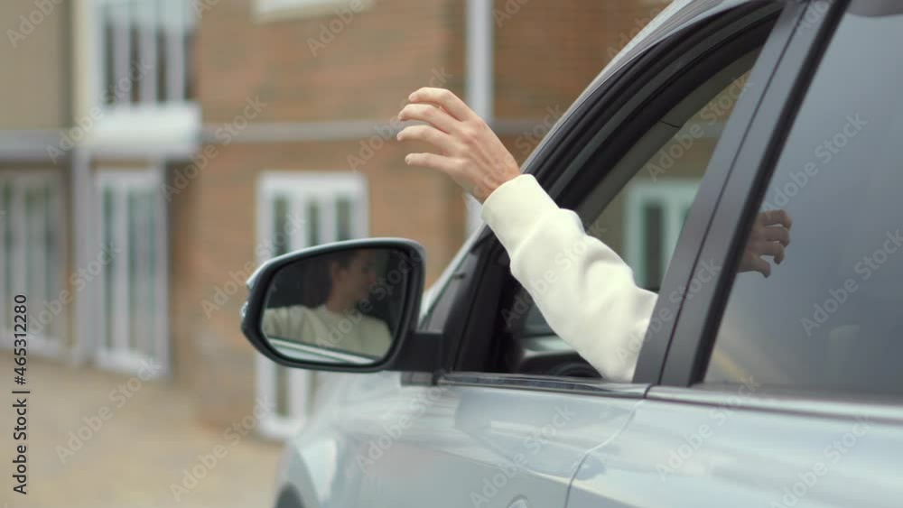 woman arm driver drank coffee and threw glass out window. Silver car in ...