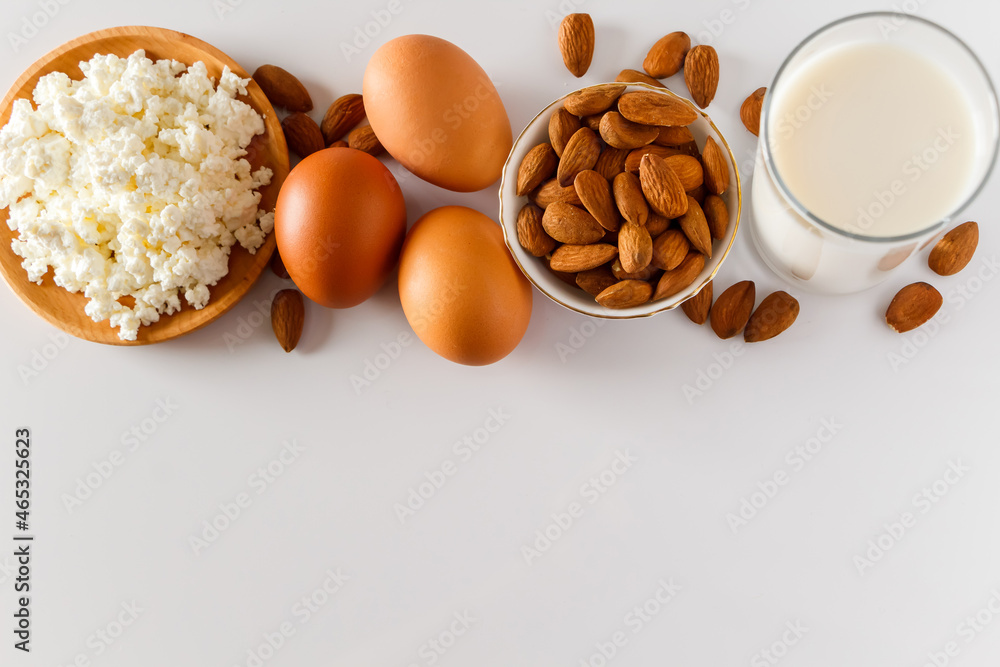Protein food on a white background - cottage cheese, eggs, nuts. A set ...