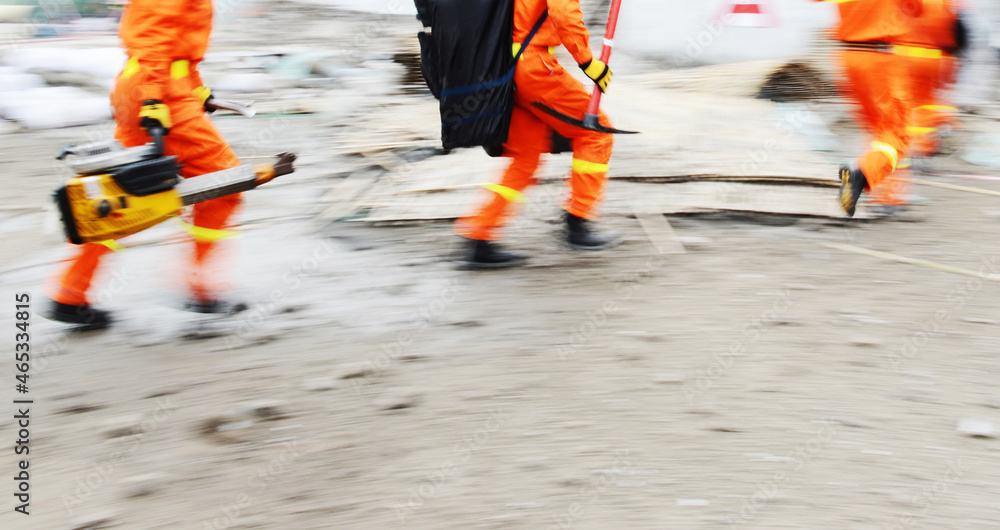 Search and rescue forces search through a destroyed building. blur ...