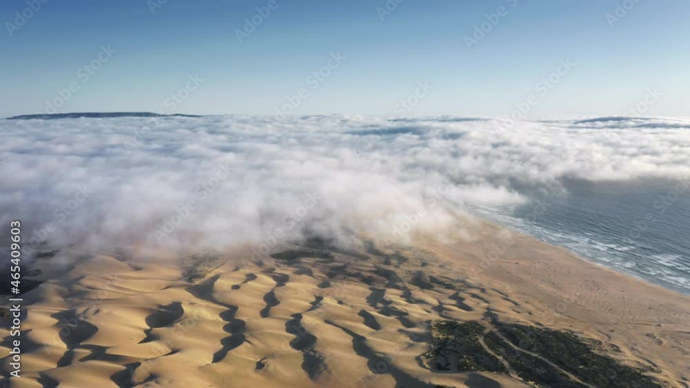 A dune field, covered by extensive sand dunes, within coastal landscape ...
