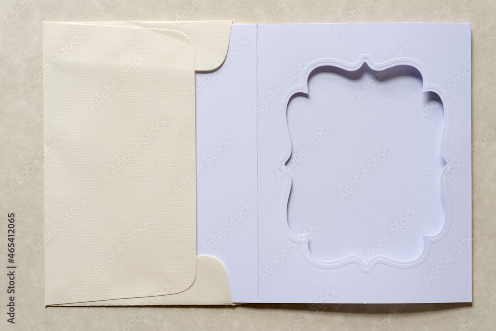 plain die cut paper card with fancy window opening inside an envelope ...