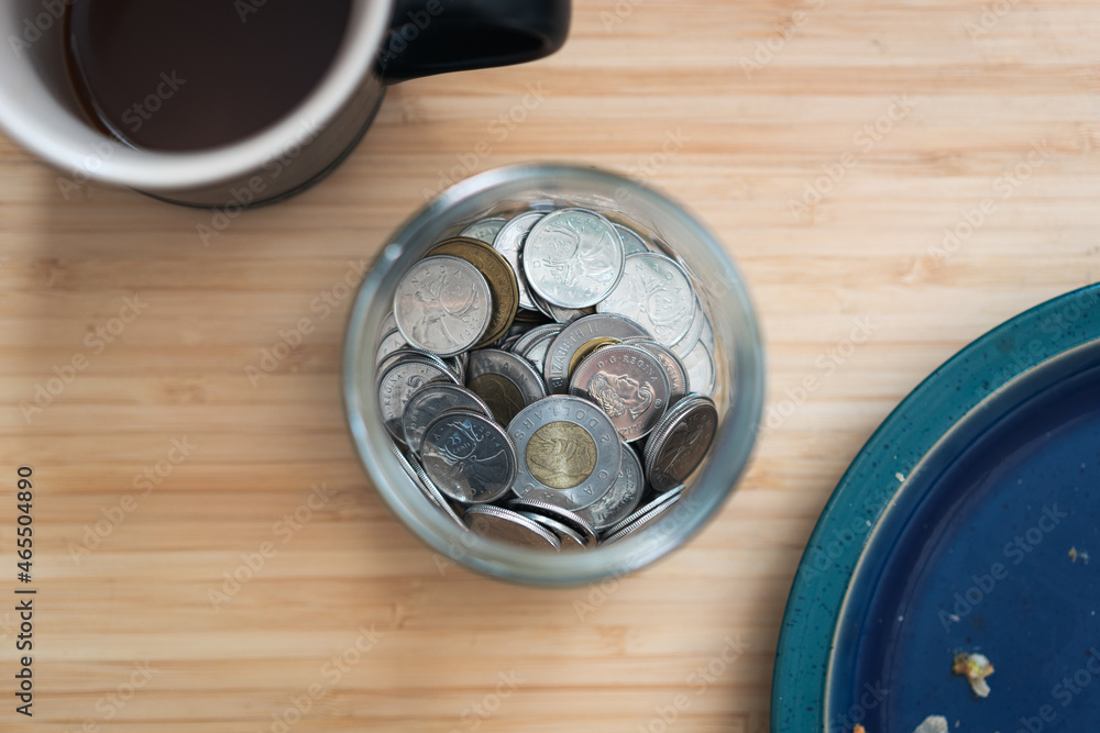 Poster Canadian toonie loonie and quarter money in jar on a desk – Wall ...