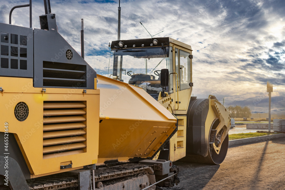 Asphalt paving equipment. Asphalt paver and heavy vibratory roller ...