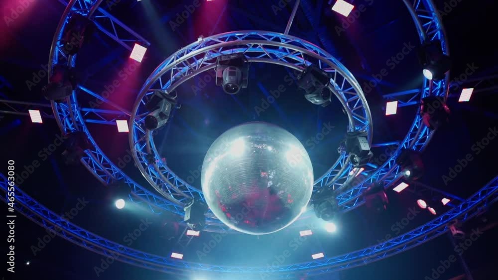 Stage lights and disco ball in club with smooth movement. Many colors ...