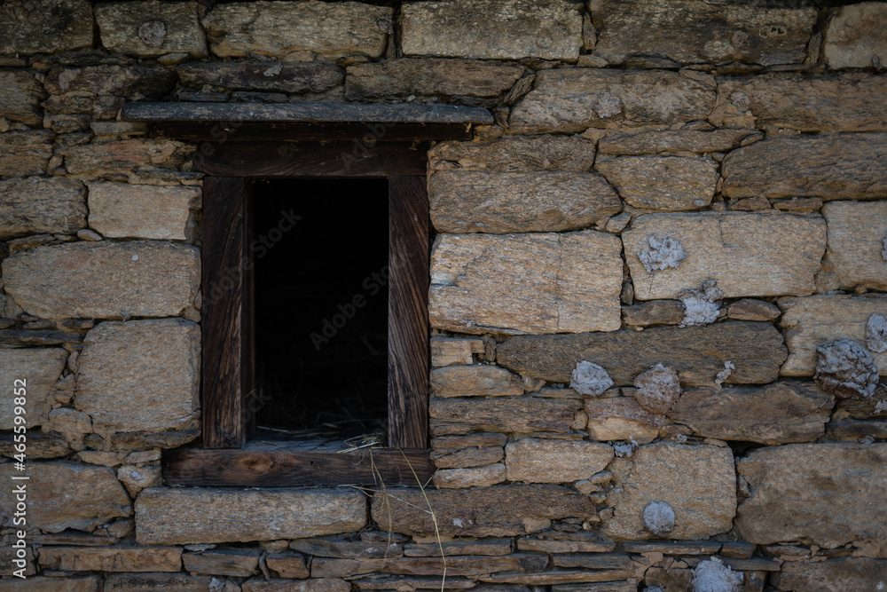 Old ancient window frame in the wall of cement bricks. A window frame ...