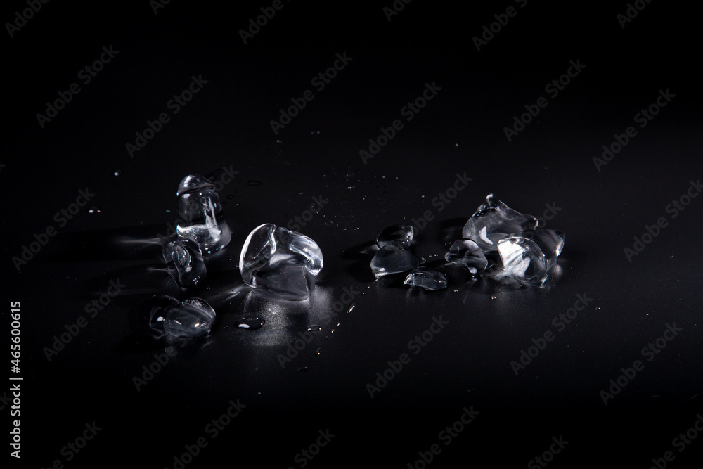 pieces, fragments of transparent ice on a black background. Chunks of ...