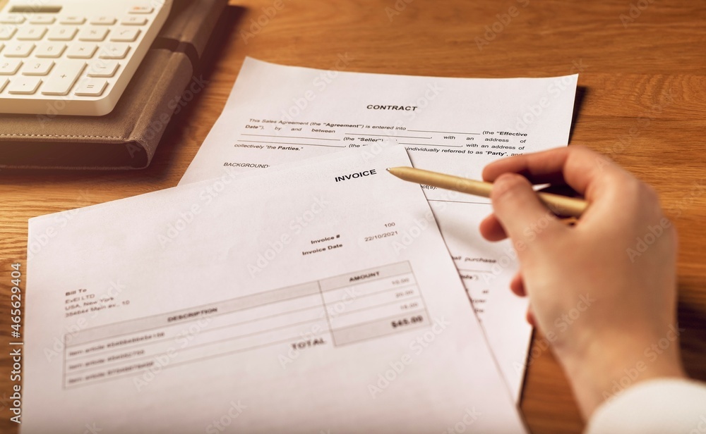 Reading and checking paper invoice and contract concept. Business bill ...