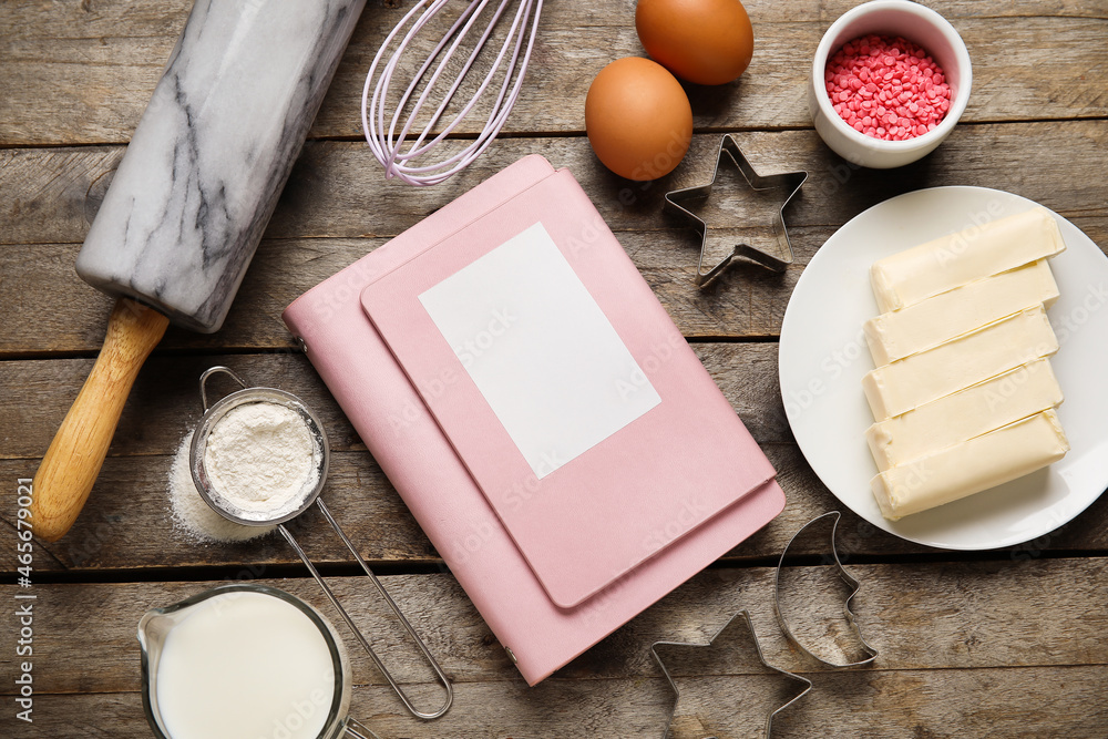 Recipe book with various ingredients and kitchen utensils on wooden ...