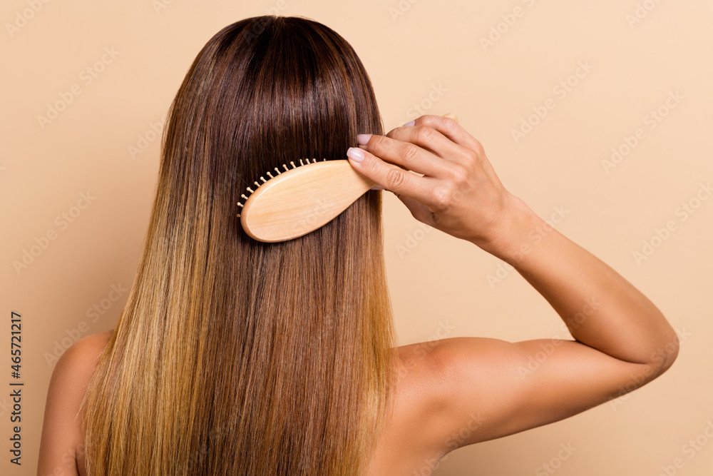 Rear back behind view portrait of attractive woman combing smooth silky ...