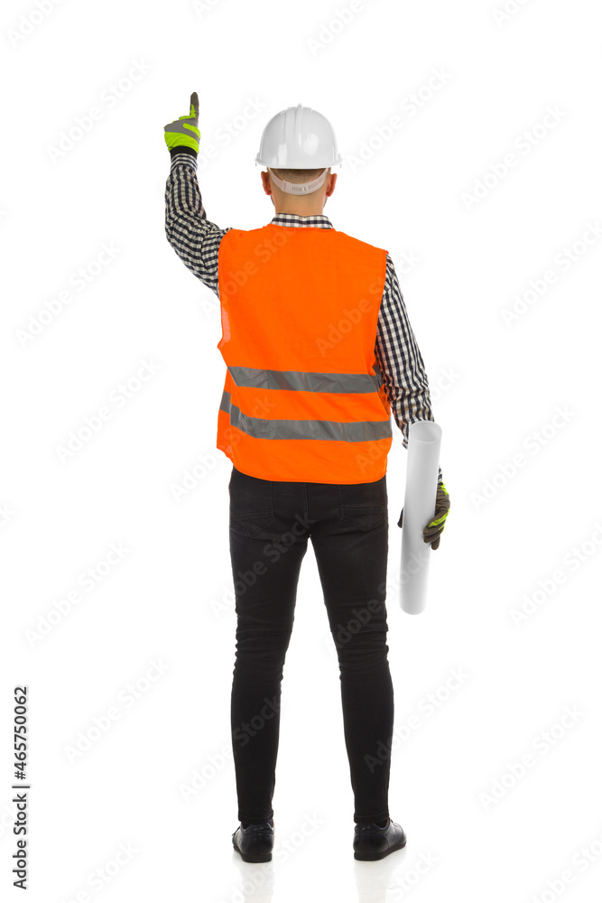 Engineer in reflective waistcoat and white helmet is standing and ...