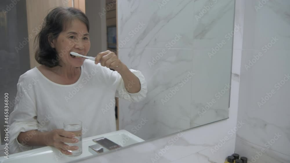 Health concept of 4k Resolution. Asian old woman brushing teeth in the ...