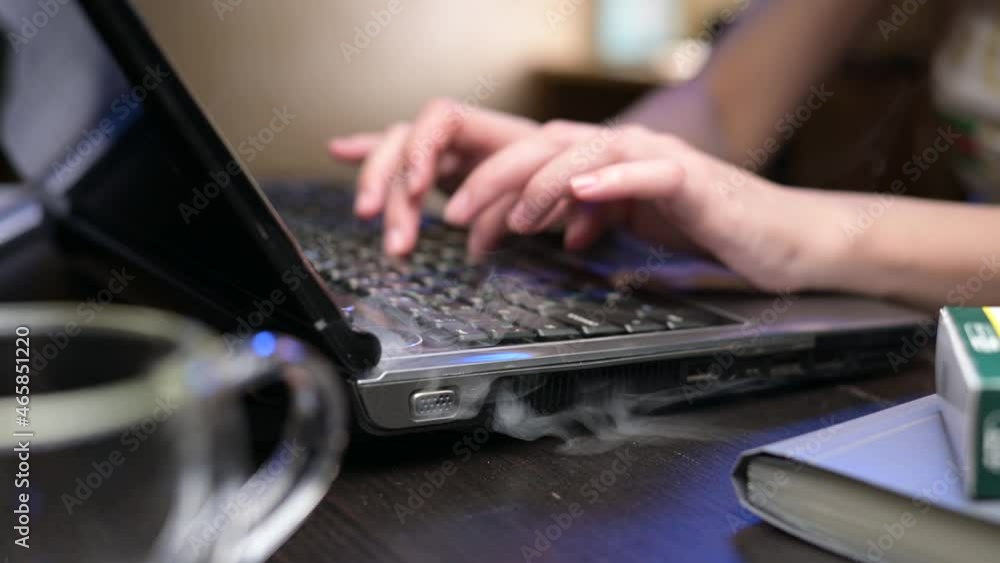 Vídeo do Stock: A close-up of an old laptop falling apart with smoke ...