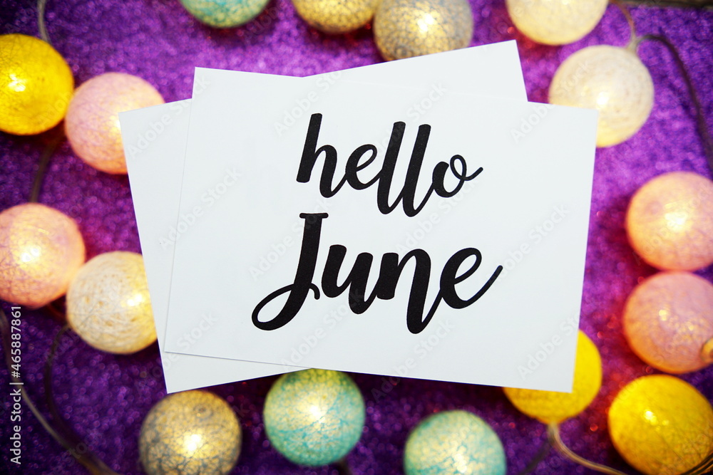 Hello June text on paper card top view on purple bokeh background Stock ...