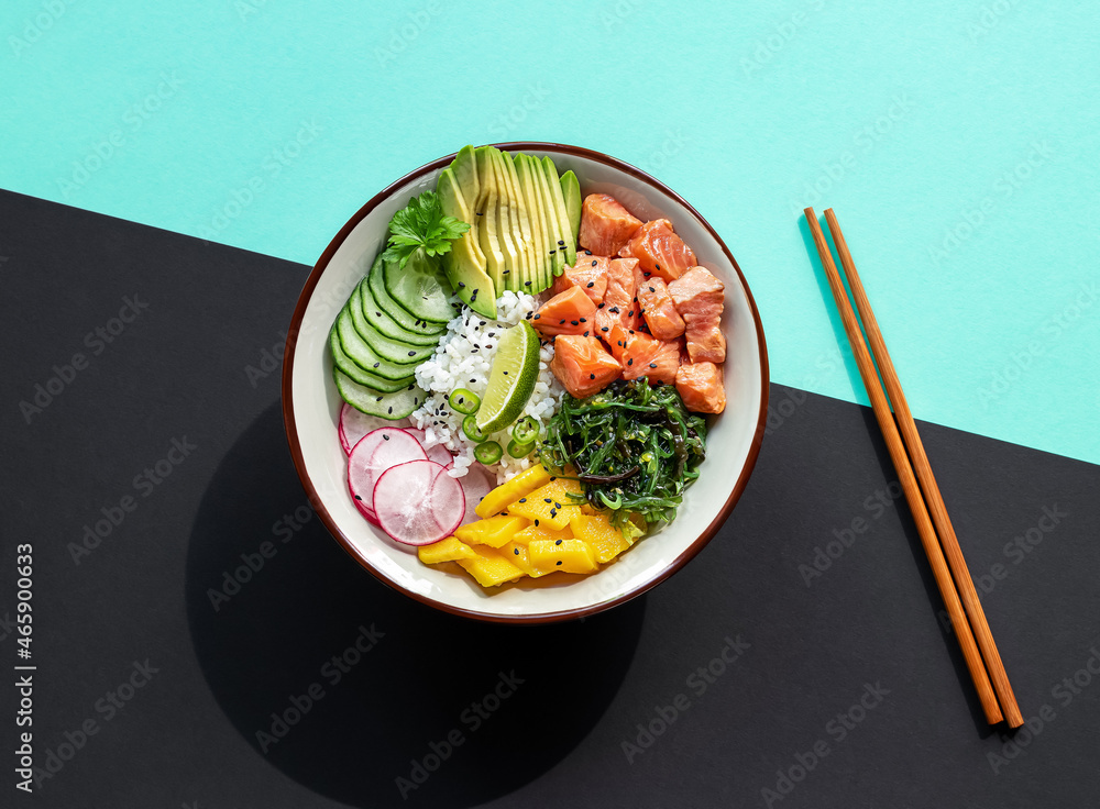 Delicious poke bowl with rice, mango, avocado, radish, chukka salad ...