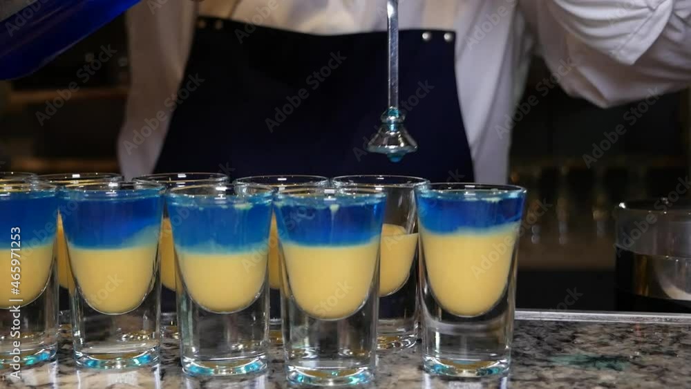 Stockvideon making colored cocktails. The color is blue and yellow ...