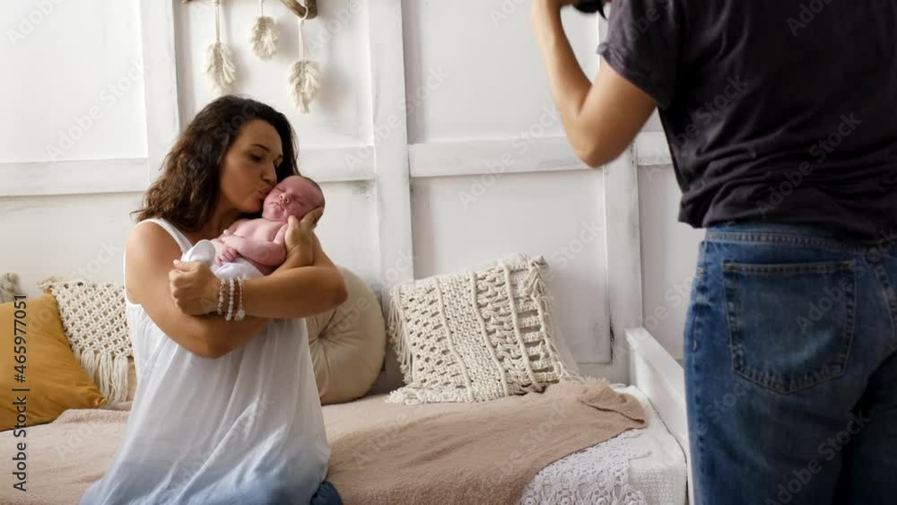 Mom holds a cute baby in her arms at a photo shoot. Ten days newborn ...