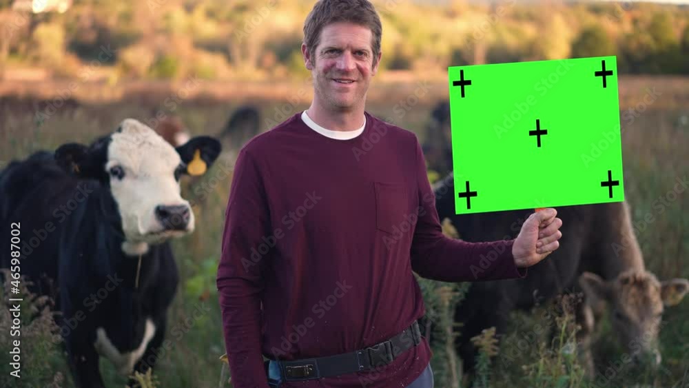 Smiling farmer man holding green screen chroma key sign surrounded by ...