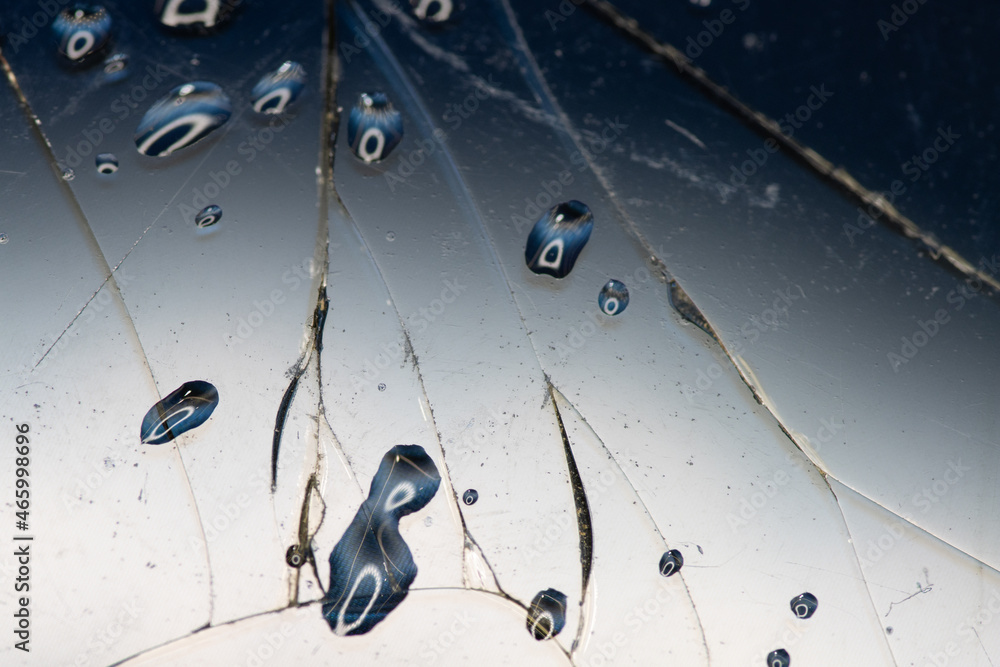 Cracked glass with water drop. Broken glass background with drop of ...