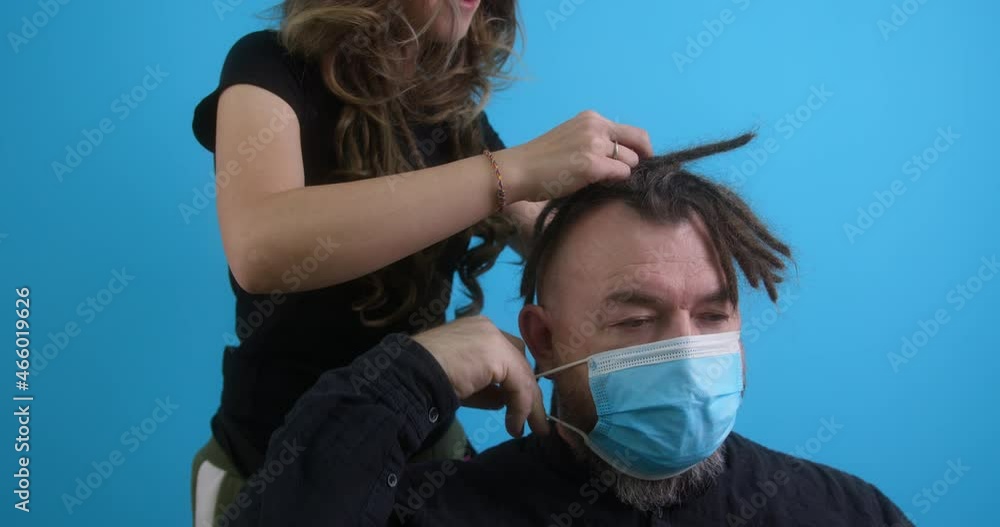 The man takes off his protective mask while the master weaves his ...