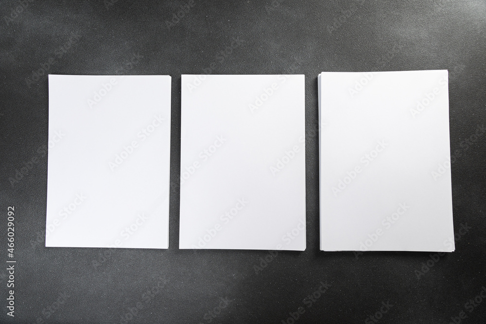 White business card sheet of paper a4 stack on a dark table. Clean ...