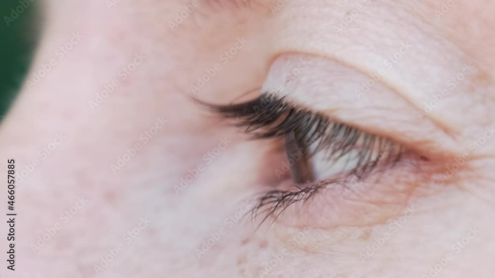 Female Brown Eye Looks into the Camera Close-up. Sad look with drooping ...