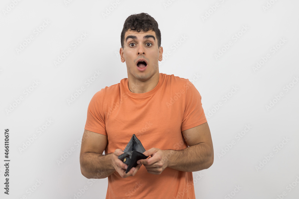 a young boy showing his wallet because he has no money on a white ...