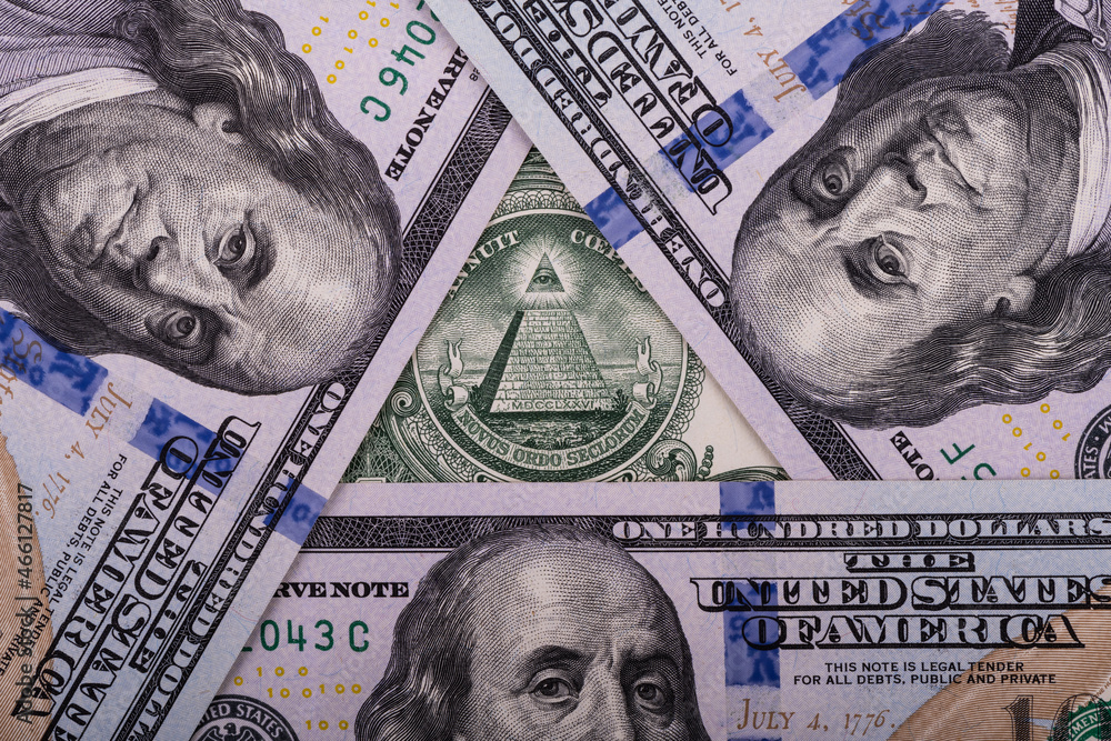 Folded 100 American dollar bills in a triangle, in the center of which ...