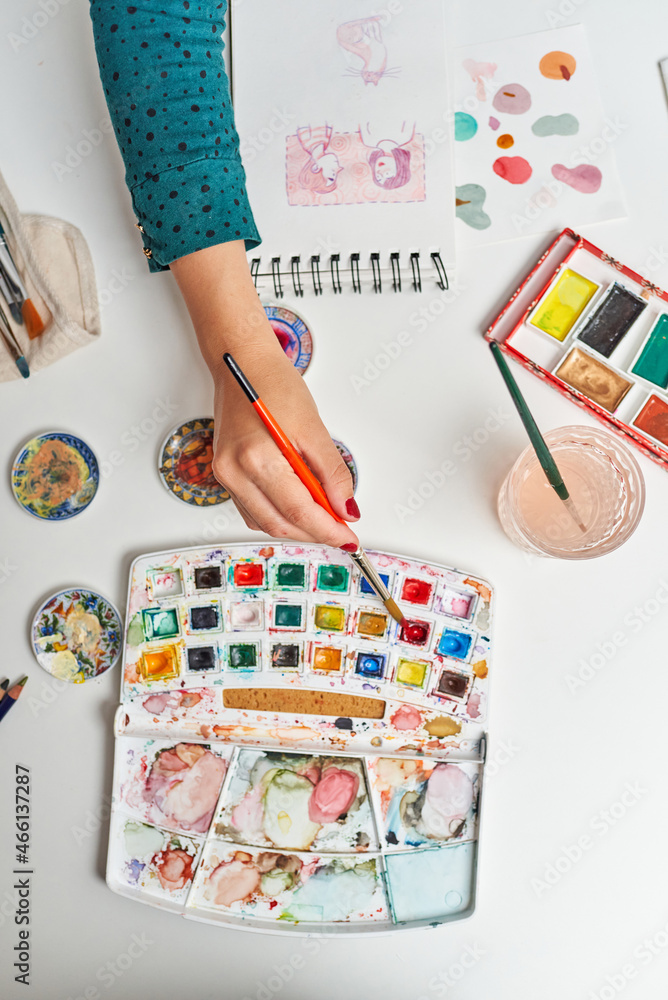 Illustrator woman paints some sketches with watercolors Stock Photo ...