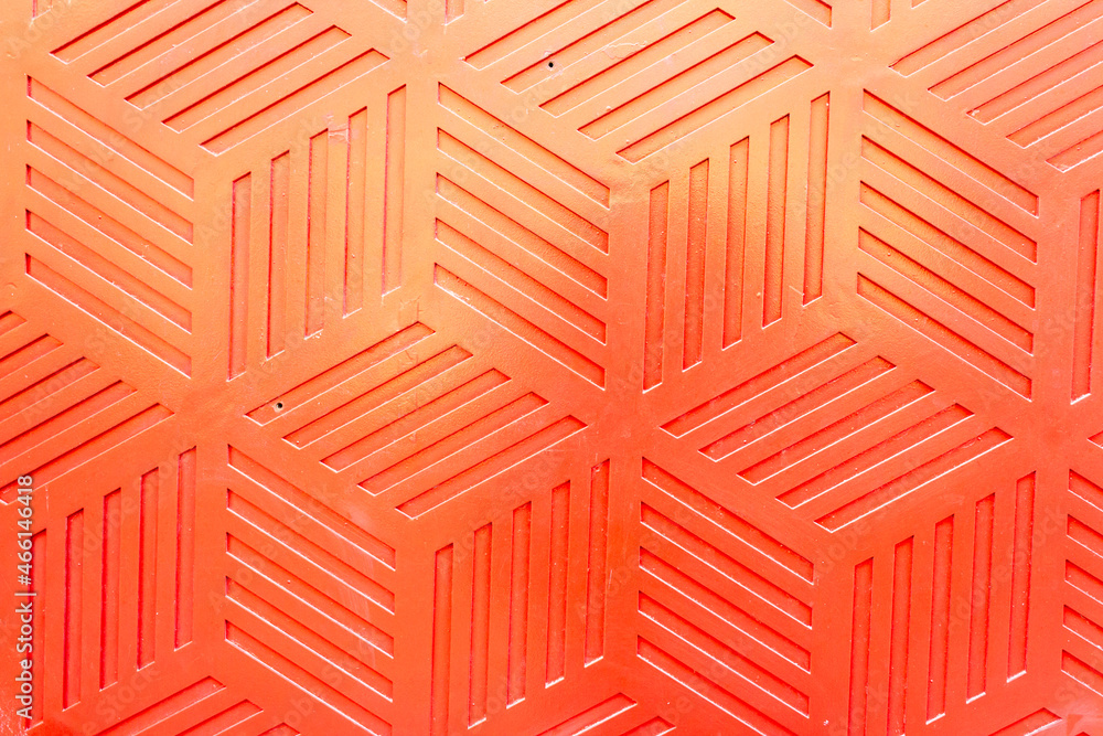 Red plastic surface with repetitive geometric shapes. Seamless ...