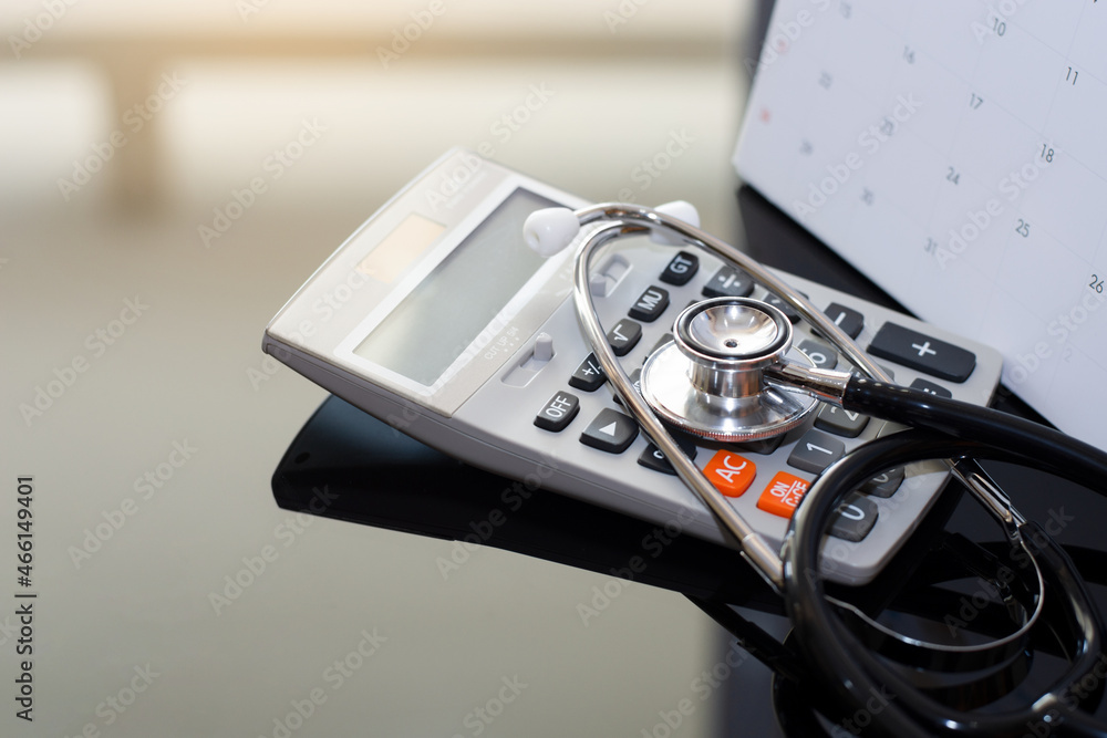 Healthcare costs and fees concept. Medical stethoscope with calculator ...