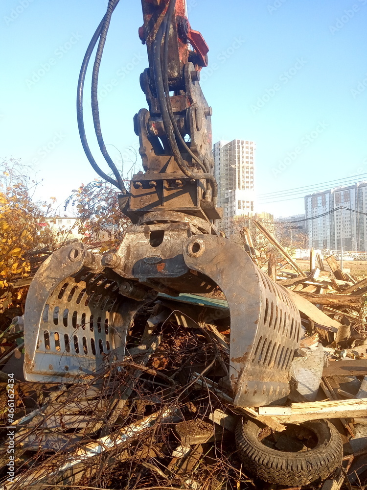 Excavator and destroyed building, earthquake, pile of rubble and debris ...