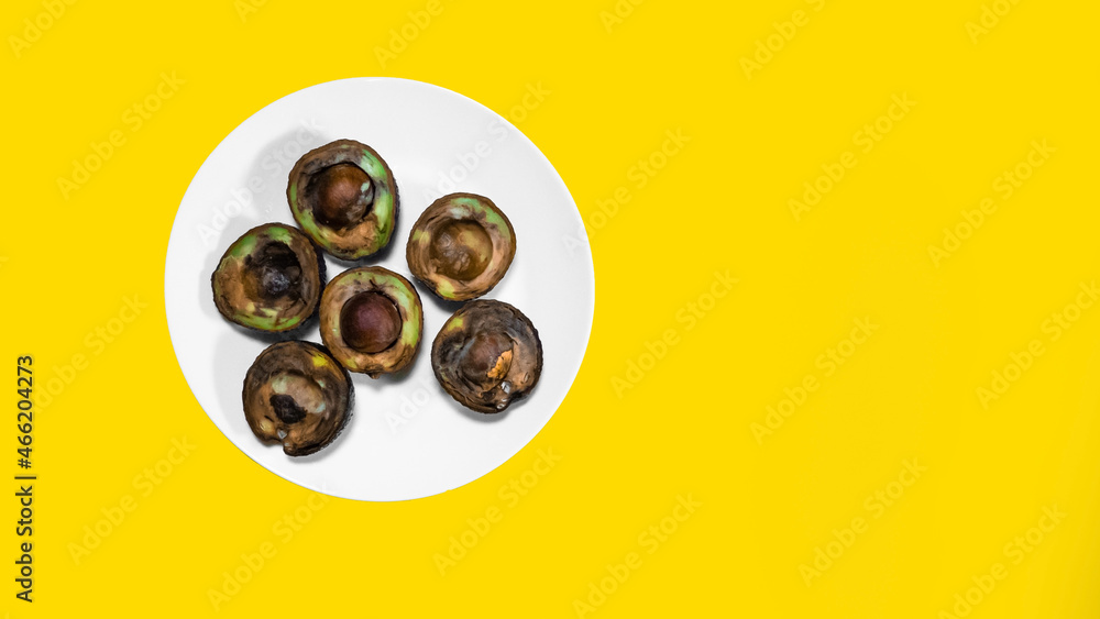 Bad Avocado halfs on Yellow background. Rotten Food Contaminated ...