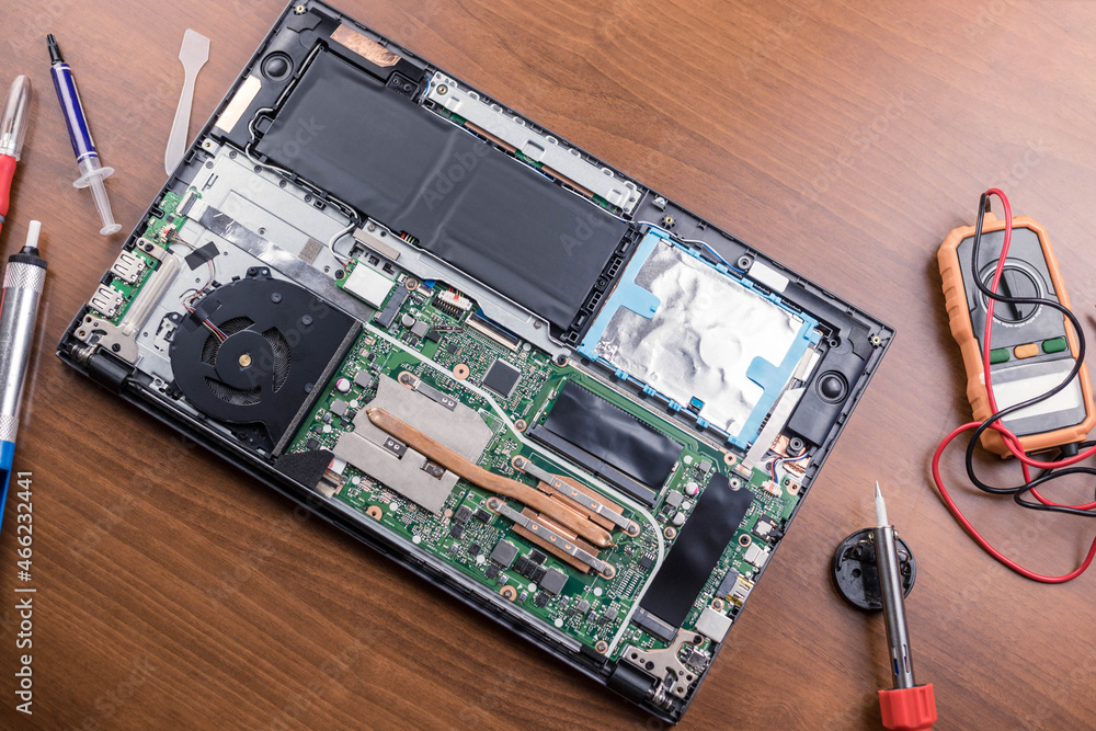 Maintenance of computer equipment using tools. View of the laptop ...