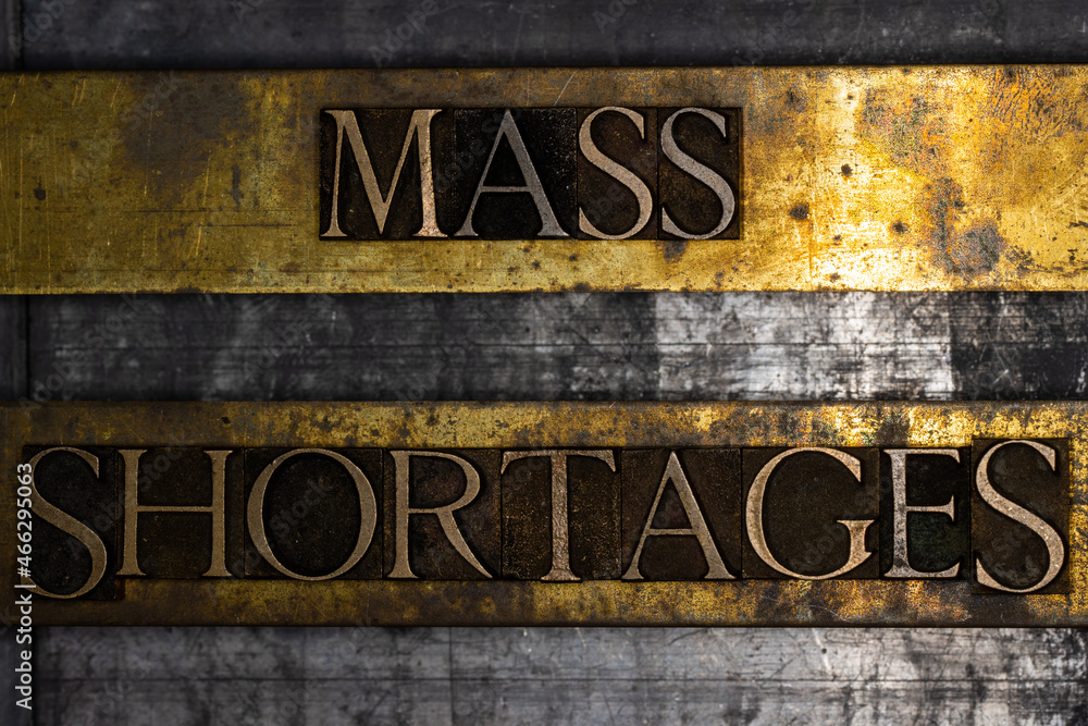 Mass Shortages text on vintage textured grunge copper and gold ...