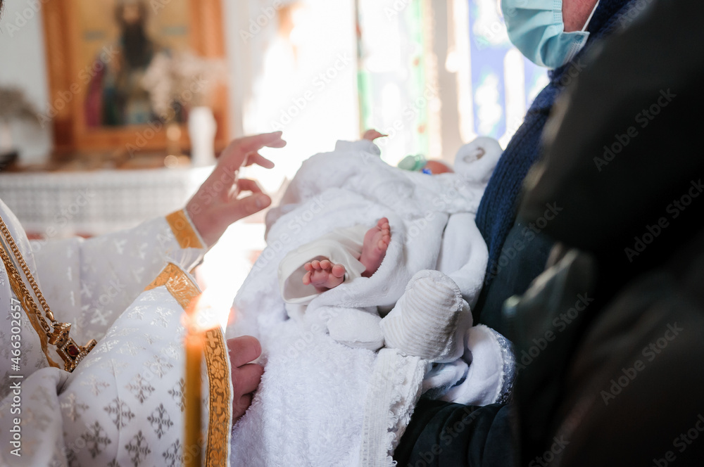 sacrament of baptism the priest baptizes the child with the anointing ...
