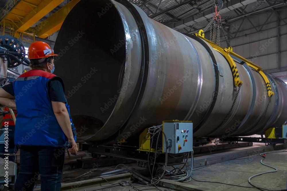 Moving pipes inside the workshop with an overhead crane using a ...