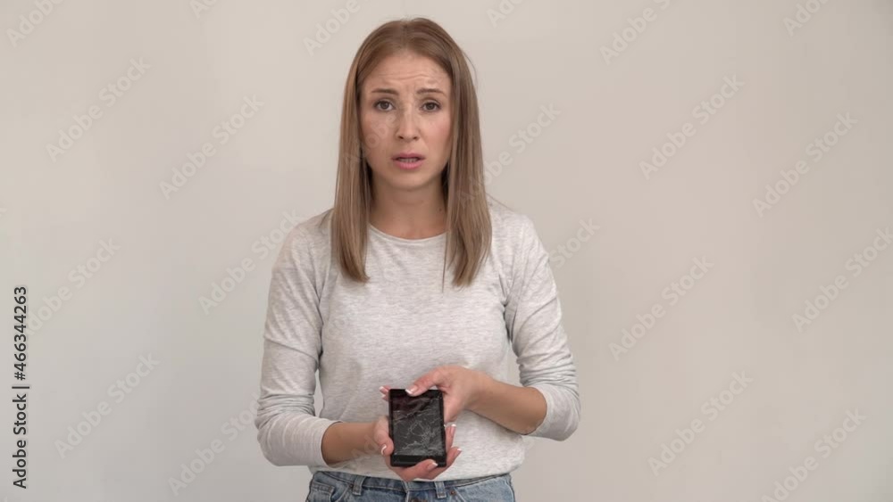 Broken glass screen smartphone in hand of upset girl. Woman crying and ...
