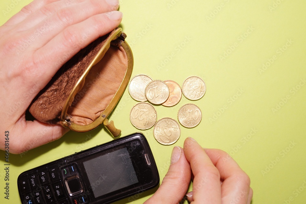 Coin purse. Wallet on a green background. Women's hands counting coins ...