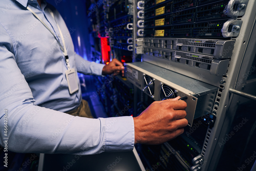 Engineer carrying out data center equipment upgrade Stock Photo | Adobe ...